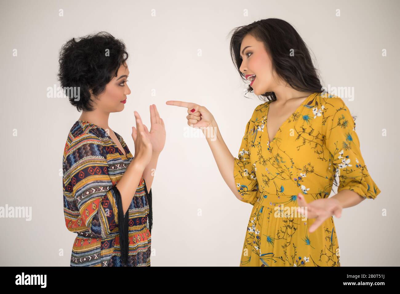 Two women arguing and distrusting each other Stock Photo - Alamy