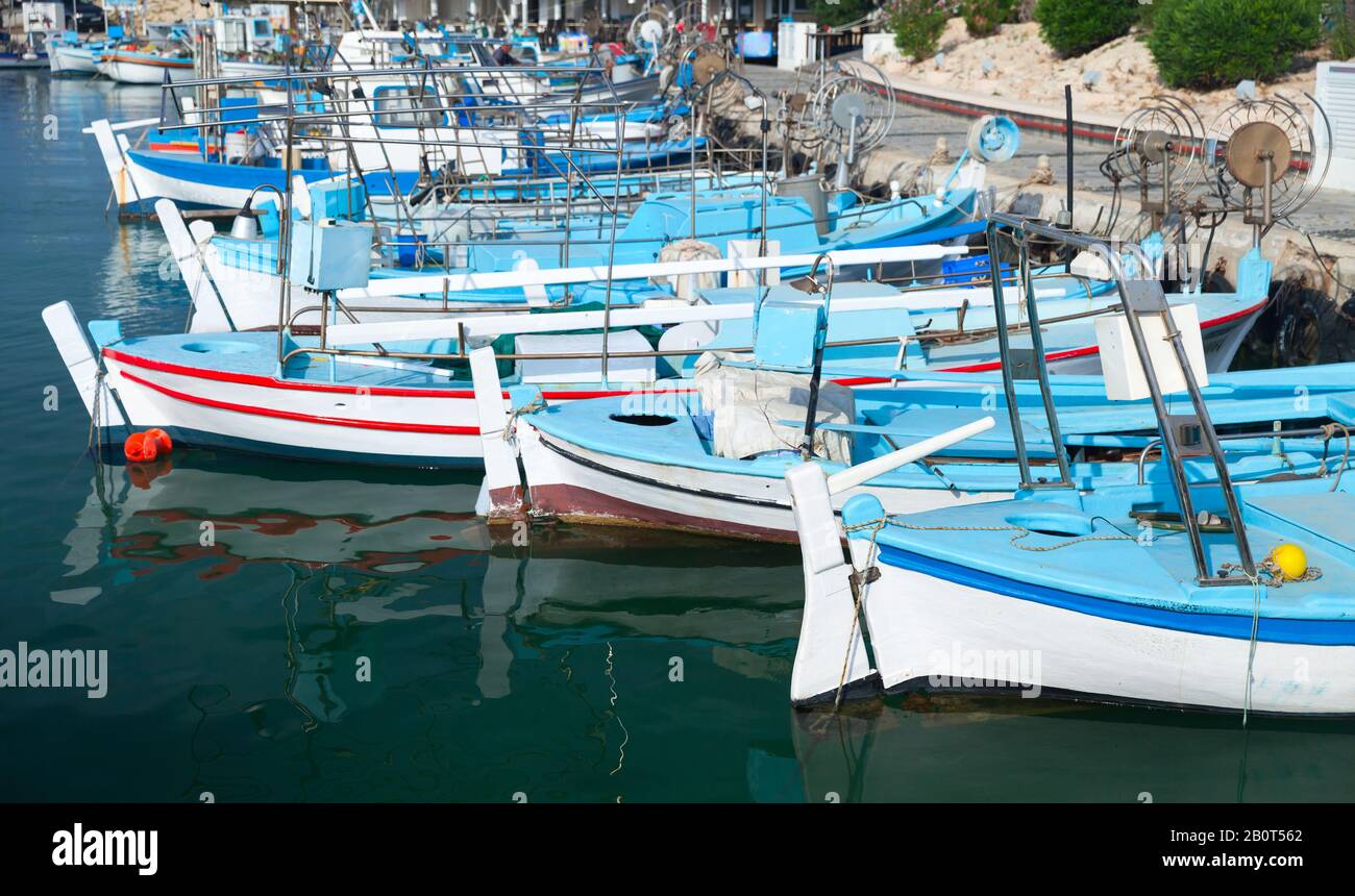 Traditional Greek white wooden fishing boats are moored in Ayia Napa ...