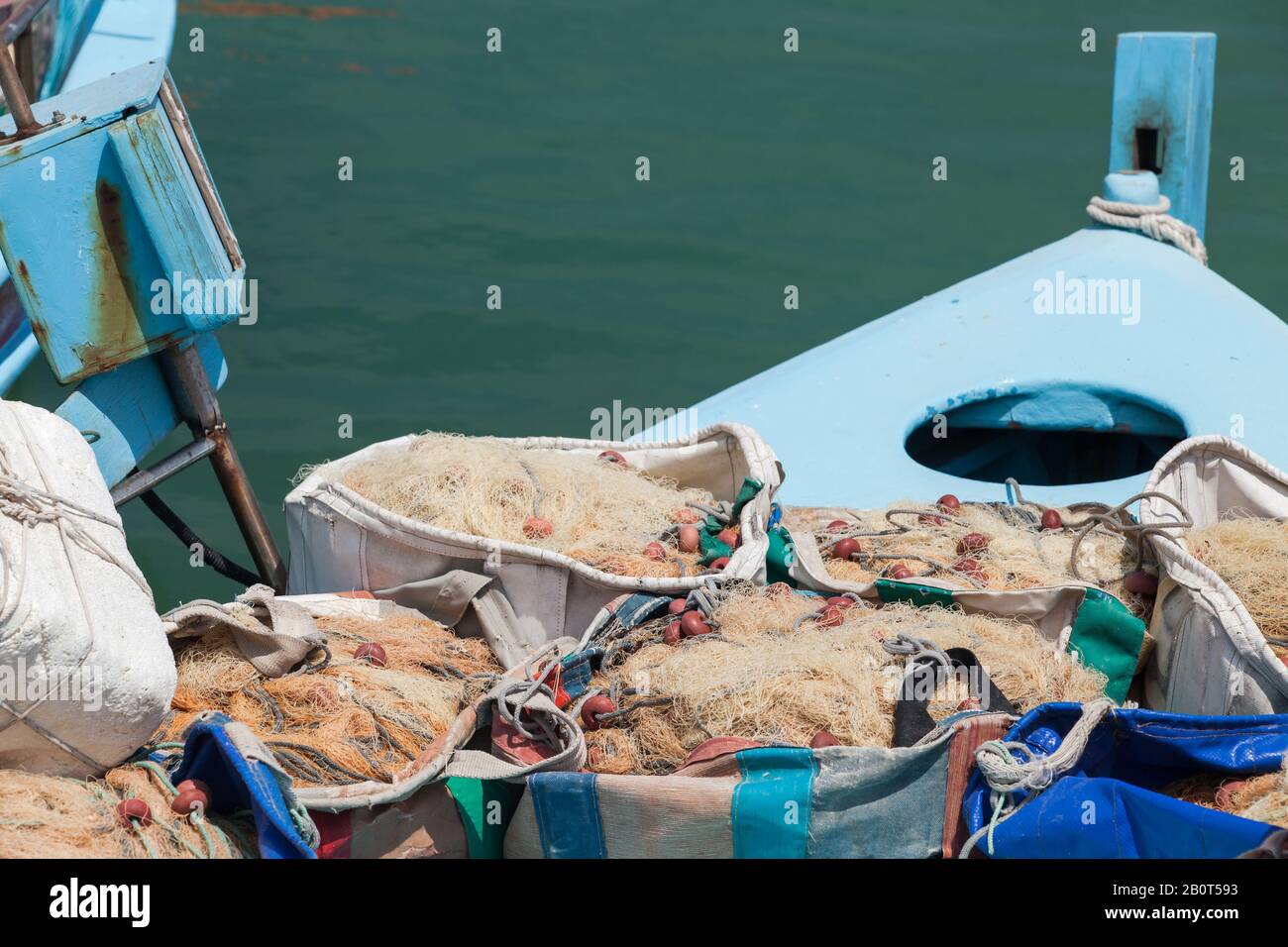 Fishing nets lay on a boat moored in Ayia Napa port, Cyprus Stock Photo ...