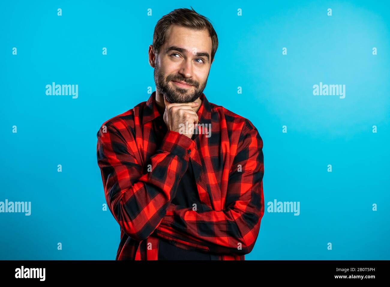 Thinking man looking up and around on blue background.Worried ...