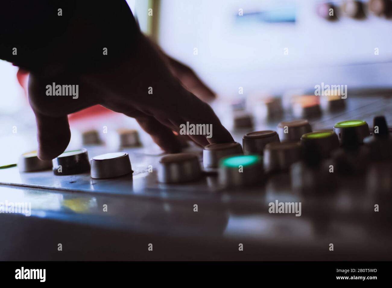 The hand on the button. Pressing the buttons on the remote control ...