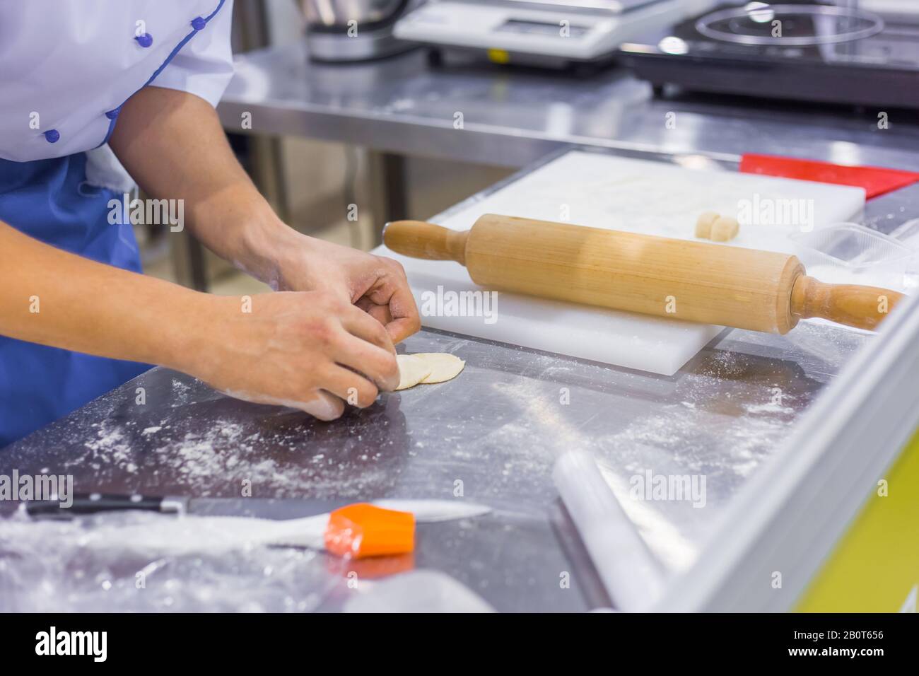 Professional cooking concept - process of preparing dough at bakery ...