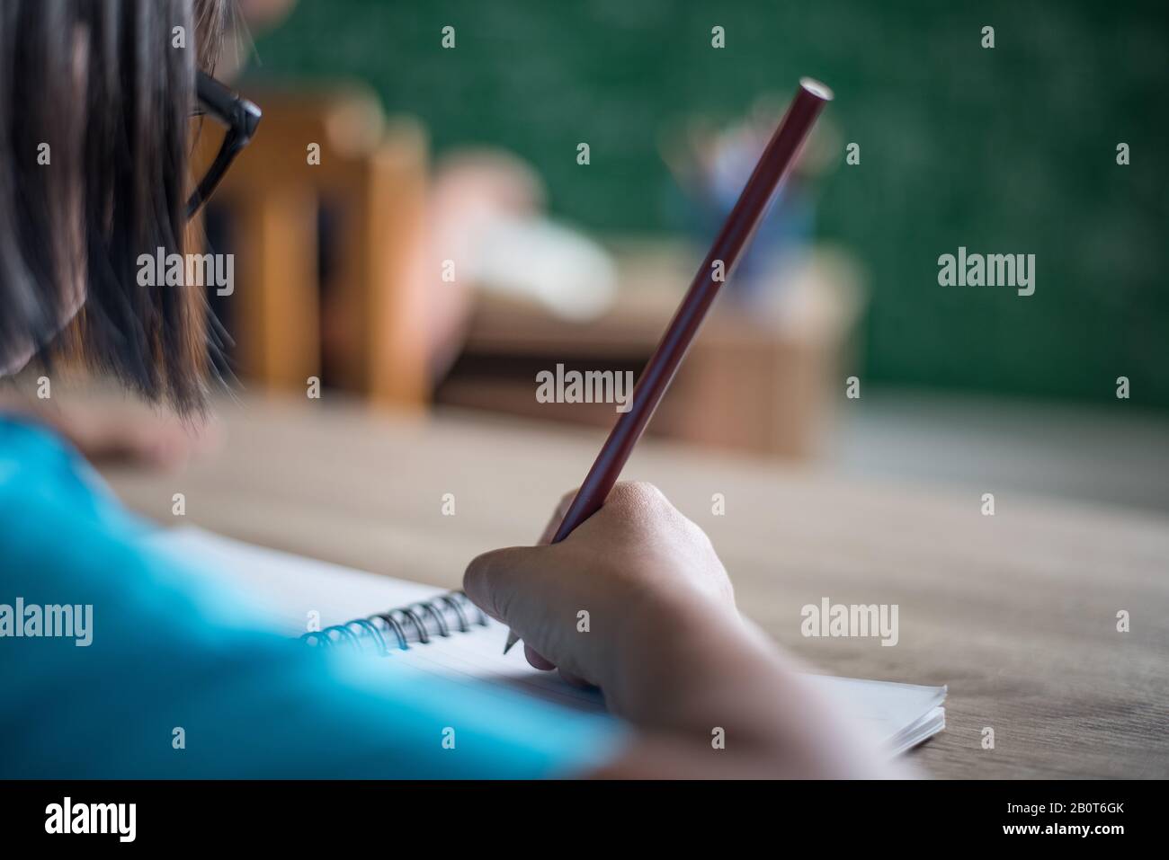 girl with crayon drawing at lesson in the classroom Stock Photo - Alamy