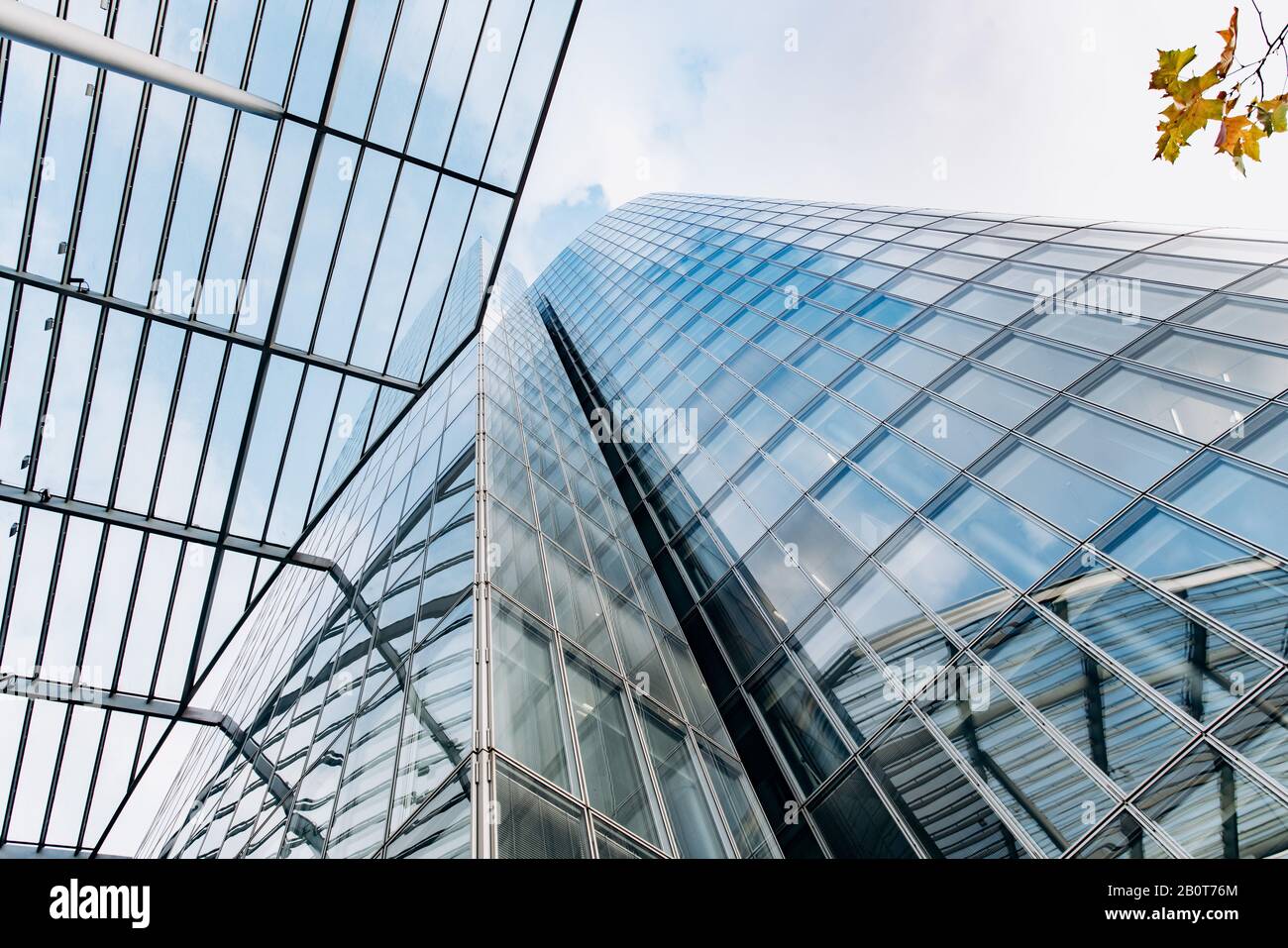 Reflection of the sky on a skyscraper. View of skyscrapers from below ...