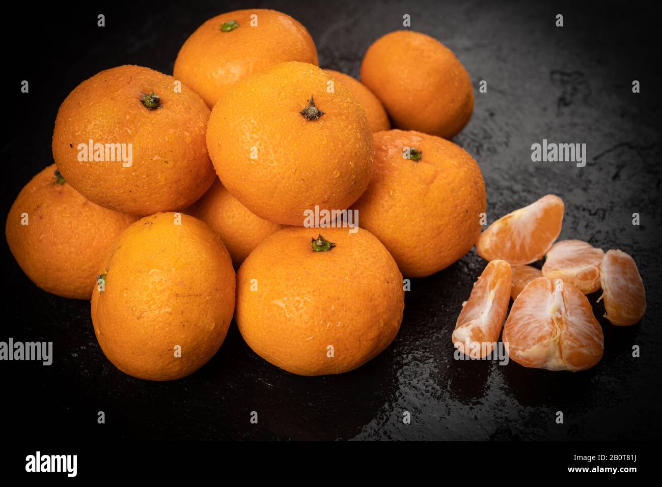 Juicy mandarin on black background. Mandarin Fruit Stock Photo - Alamy