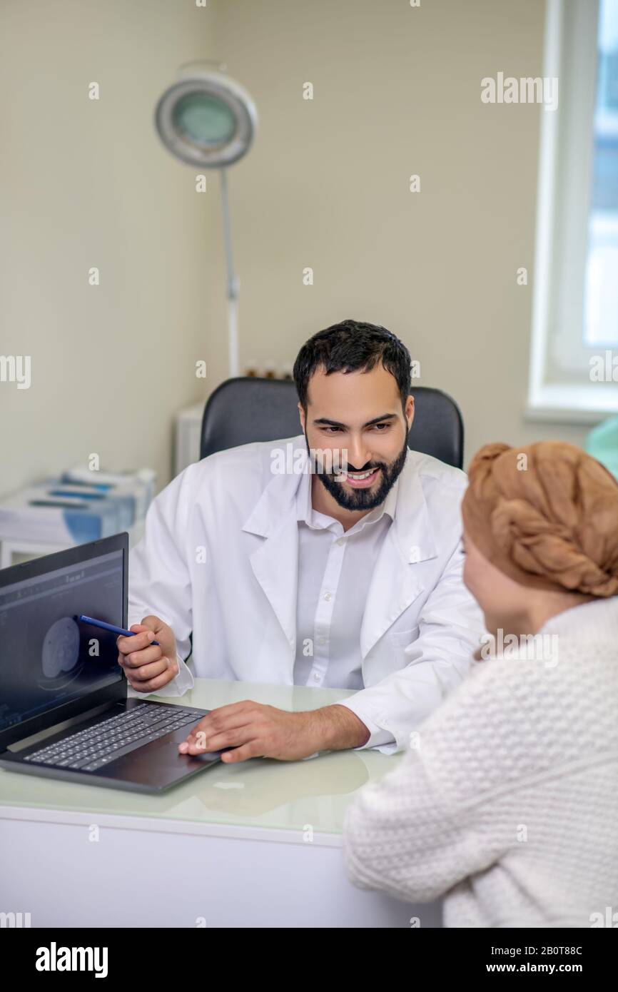 Male doctor explaining investigation results to the patient Stock Photo ...