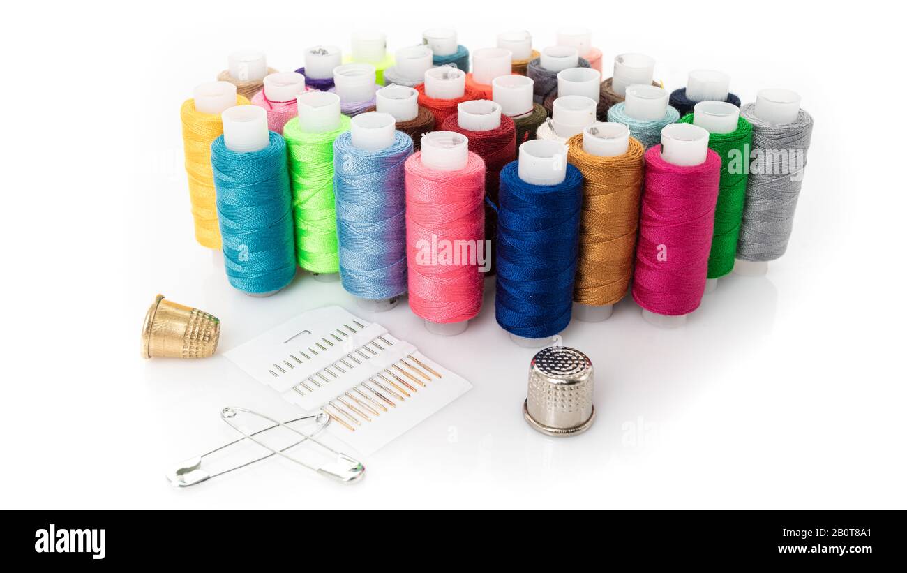 tailor needles and threads over white background Stock Photo - Alamy