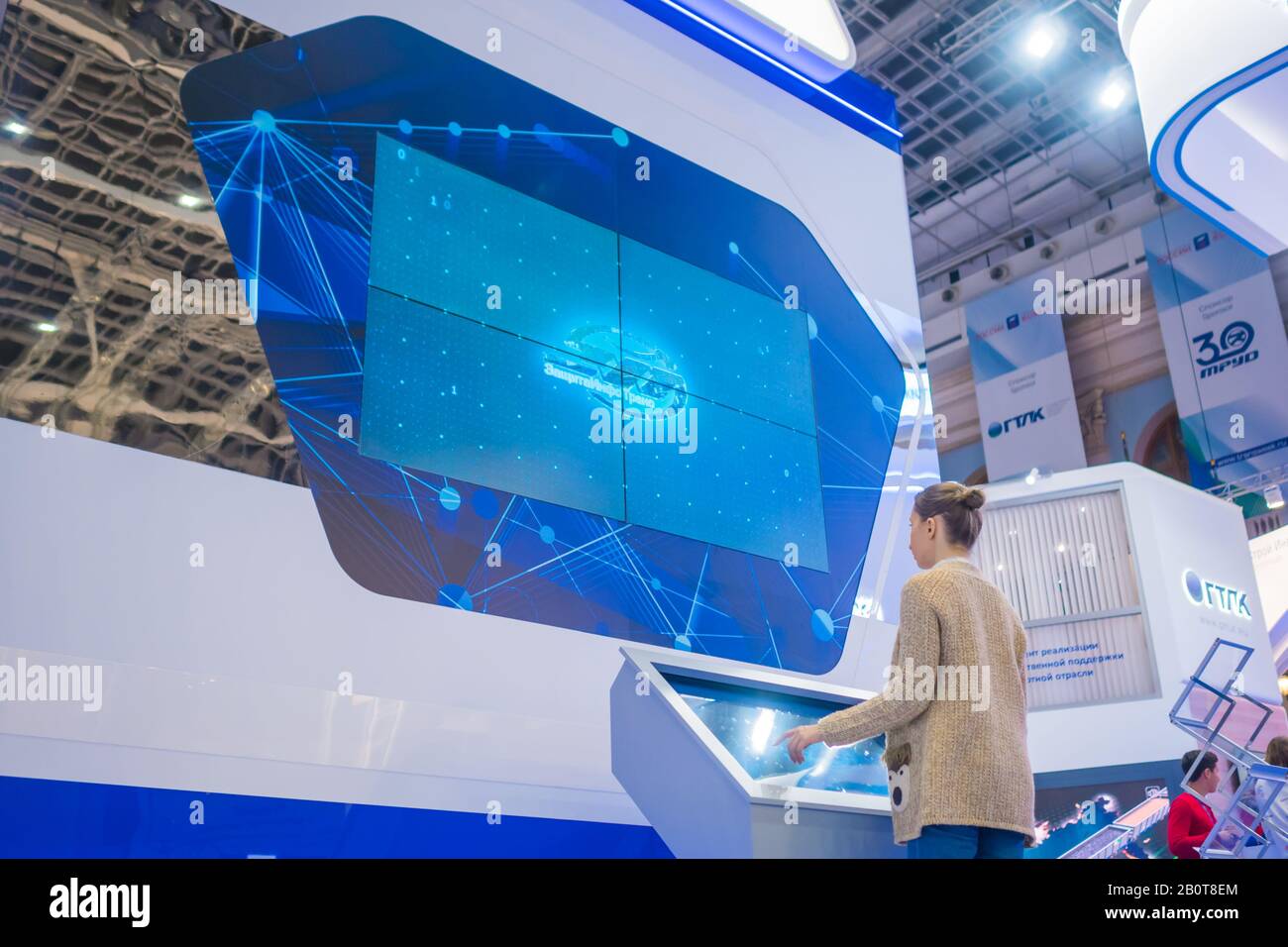 Woman reading presentation on display at exhibition Stock Photo - Alamy