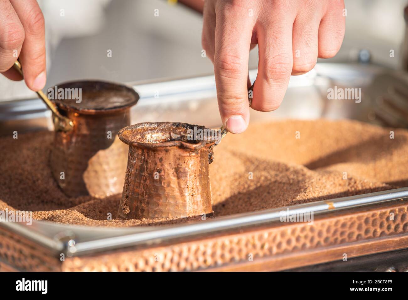 Preparation of Turkish coffee in the cezve in the sand Stock Photo - Alamy