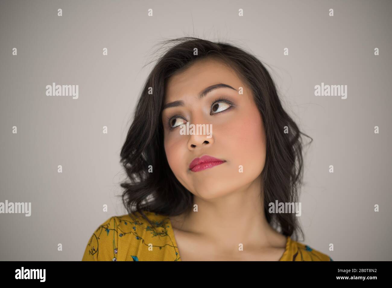 Young woman envy on white background Stock Photo - Alamy