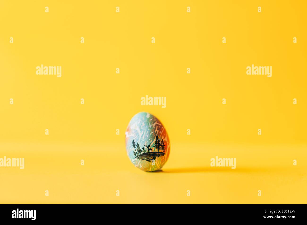color easter egg on yellow background Stock Photo - Alamy