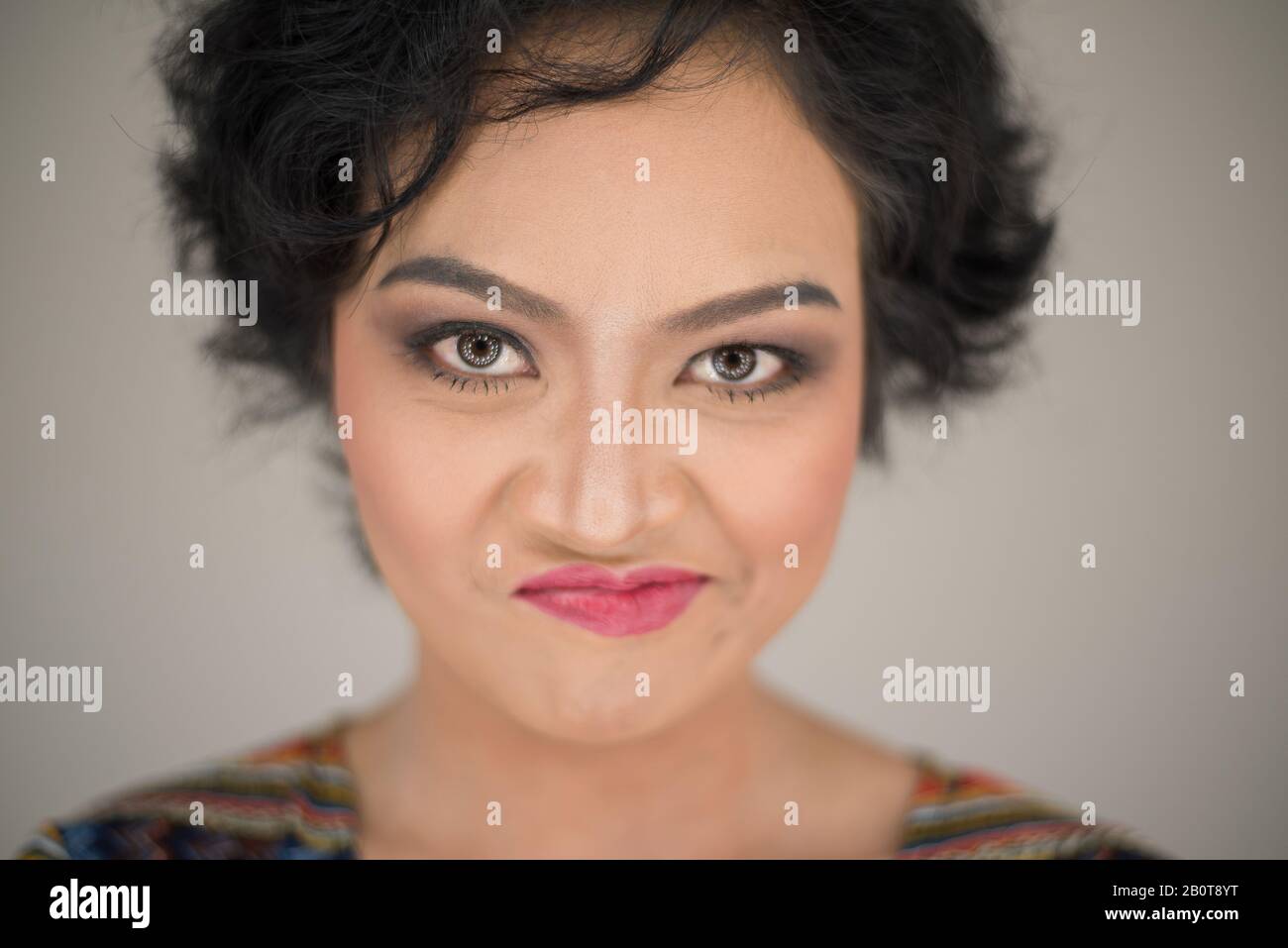 Young woman envy on white background Stock Photo - Alamy