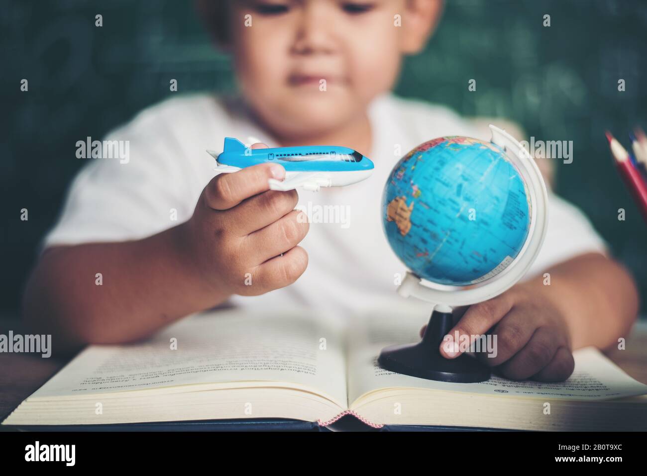 Portrait of boy with a plane model in classroom Stock Photo - Alamy