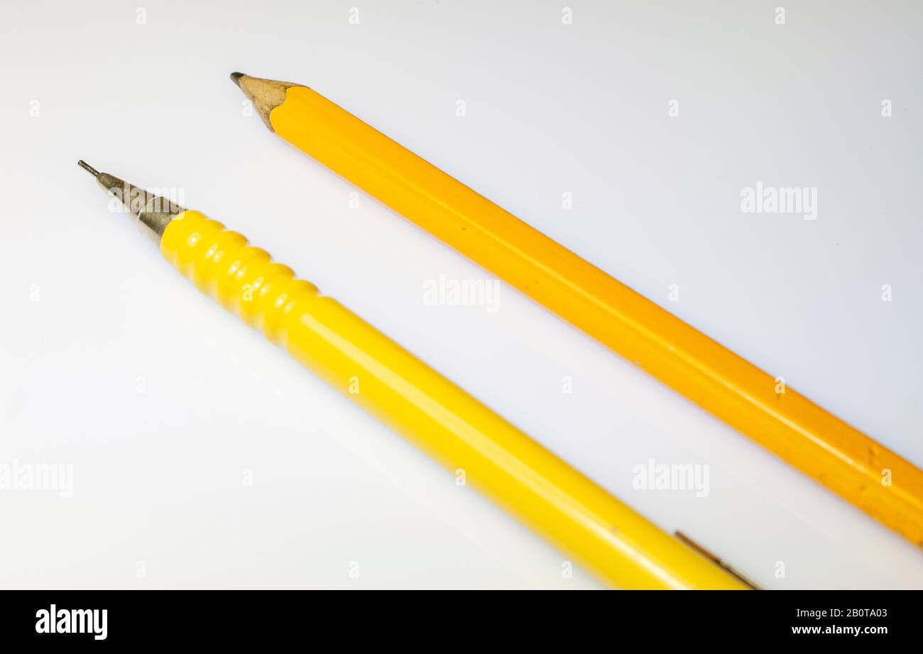 Yellow pencils on white paper background Stock Photo - Alamy