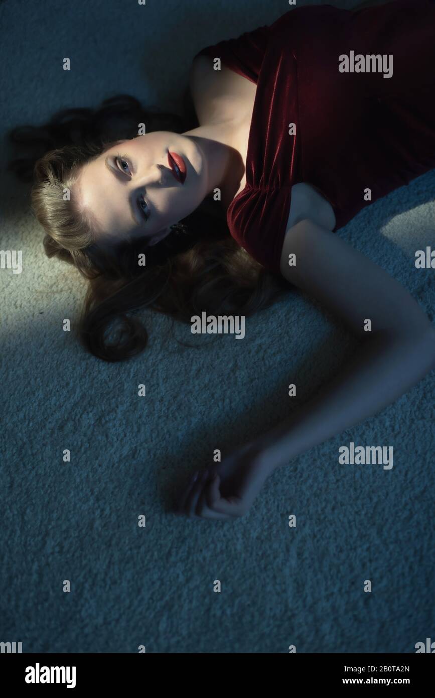 Dead woman with blonde hair in red dress on white carpet Stock Photo ...