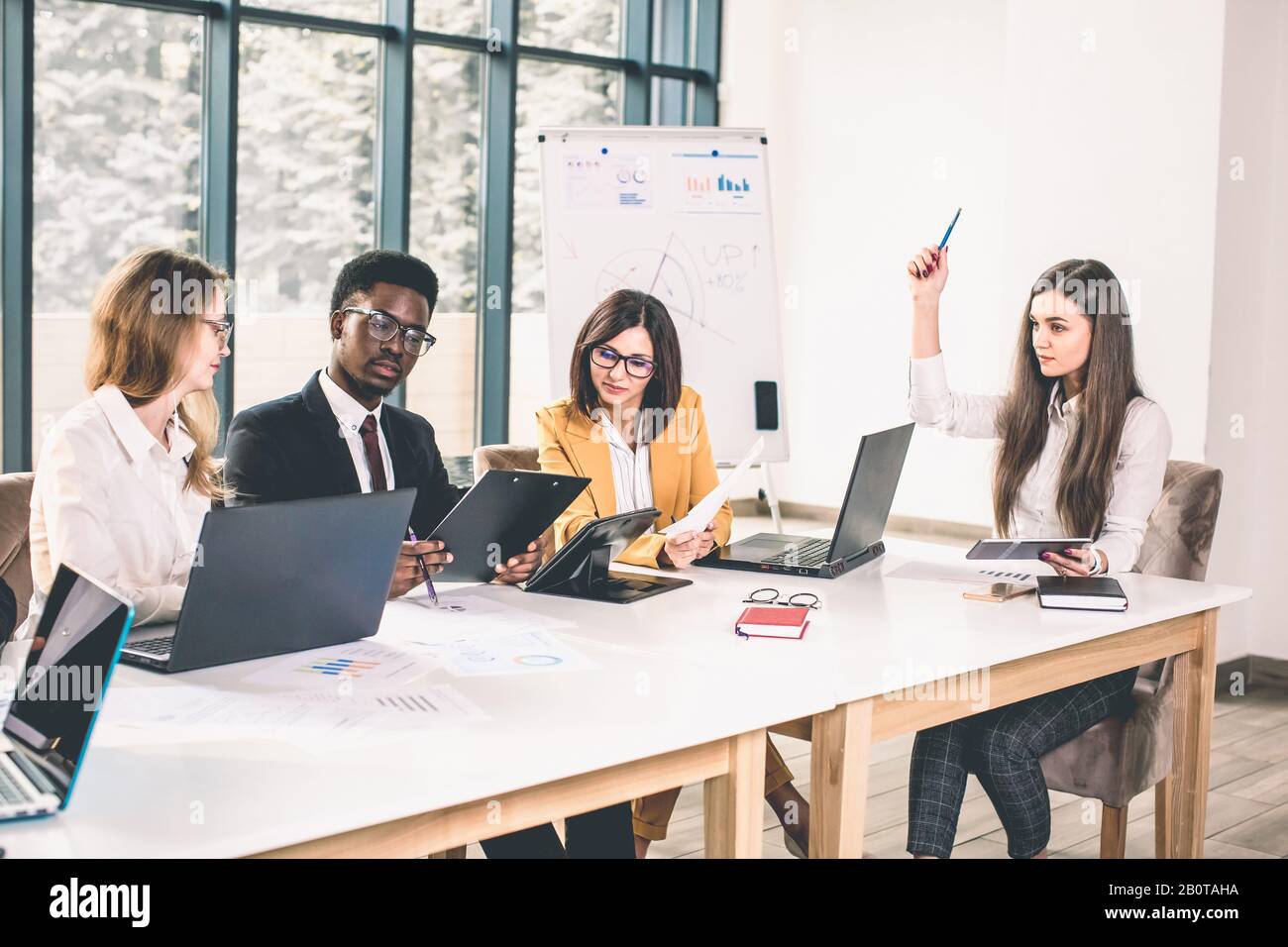 Group of Business People Using Digital Devices. Three Caucasian young ...