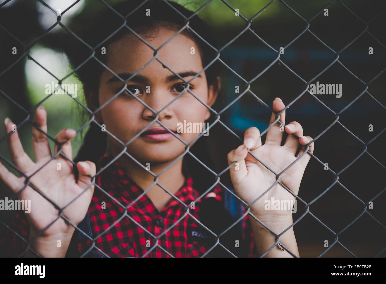 Sad girl in the cage Stock Photo - Alamy