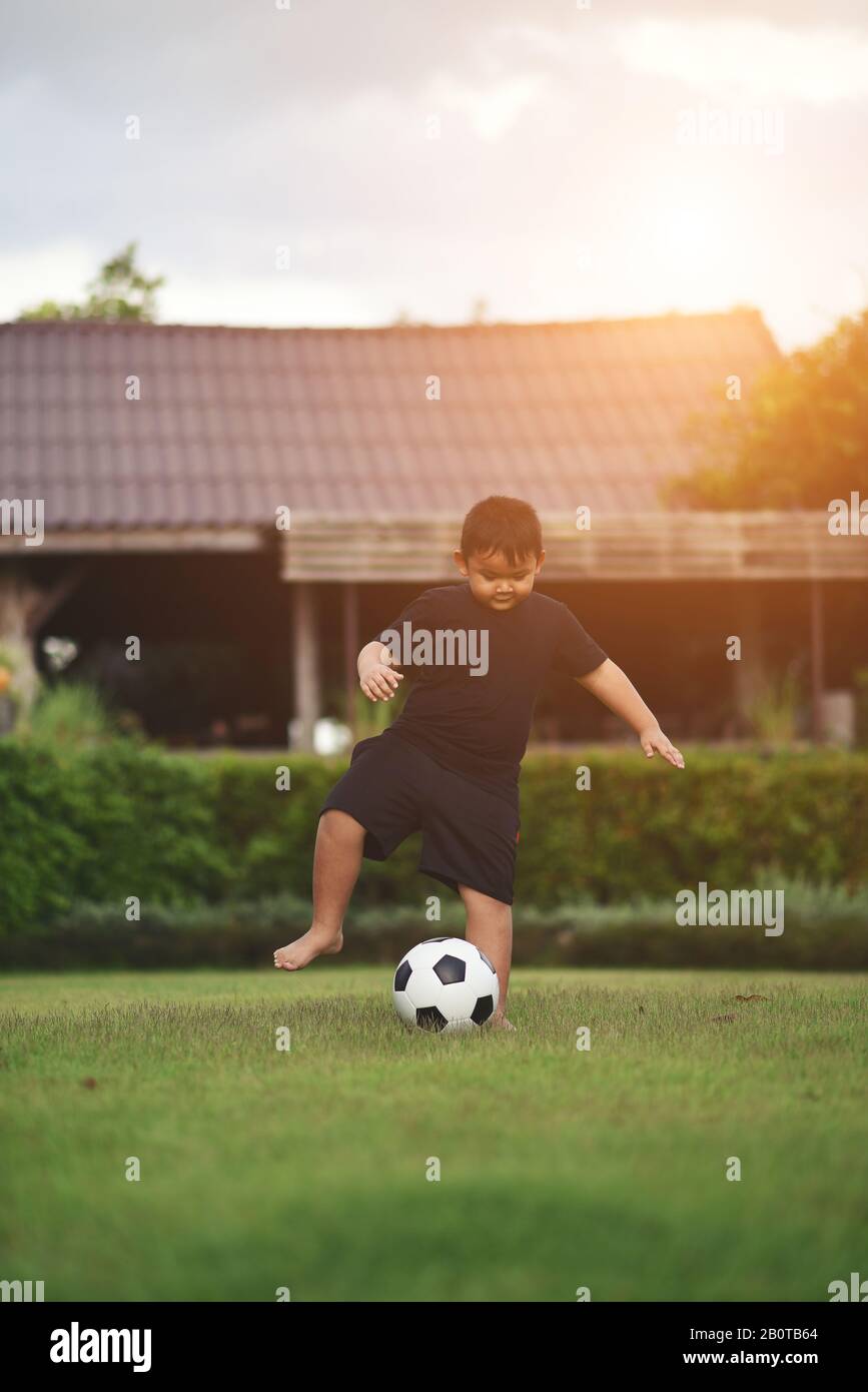 Little Boy playing soccer football Stock Photo - Alamy