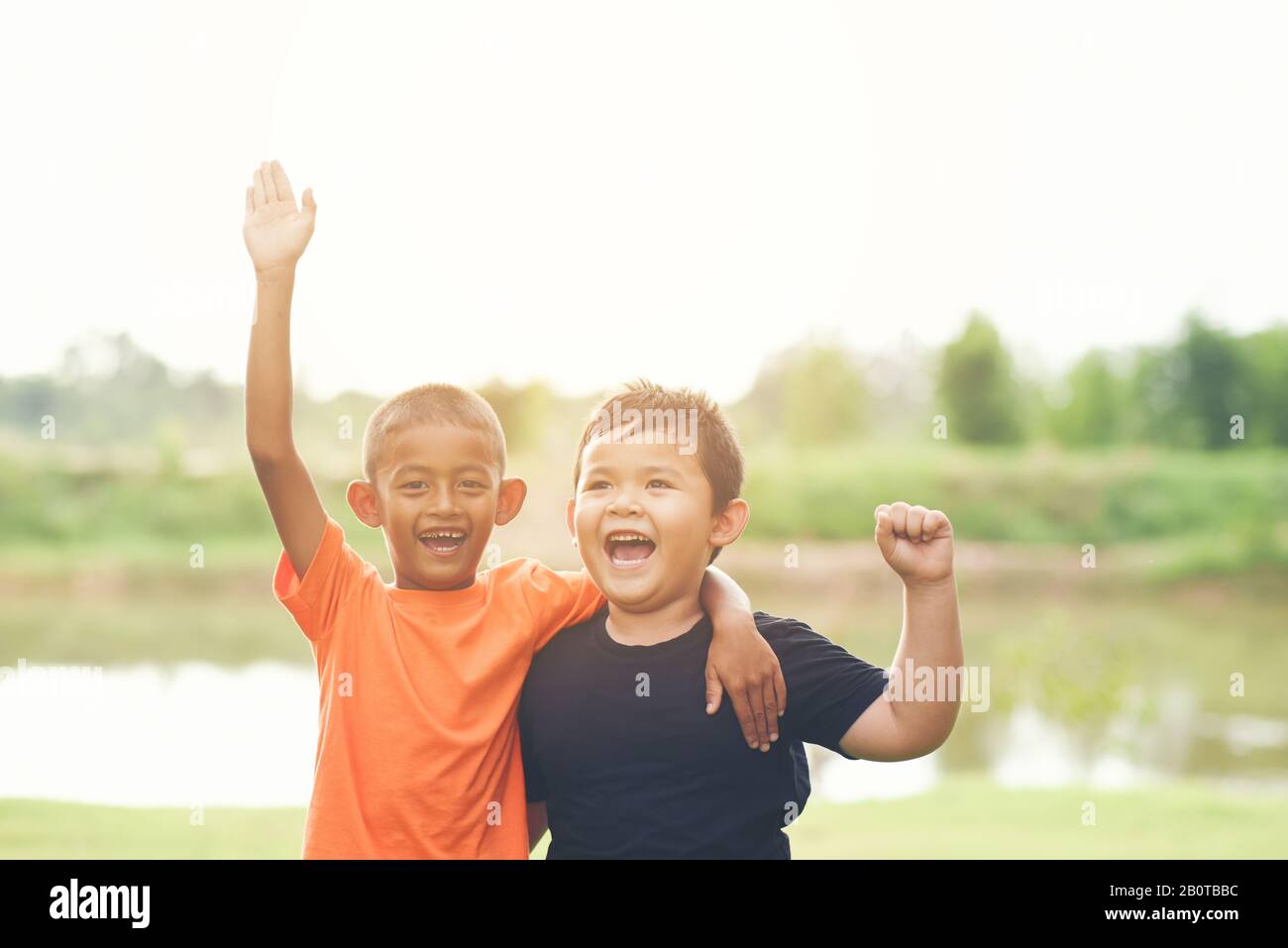 Happy two boy smiling look at camera each other Stock Photo - Alamy