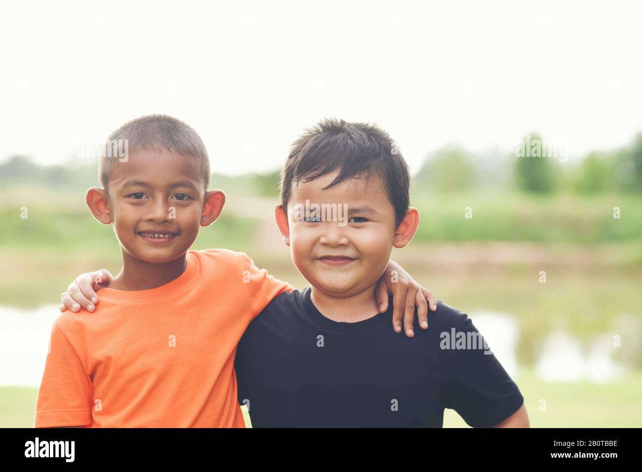 Happy two boy smiling look at camera each other Stock Photo - Alamy