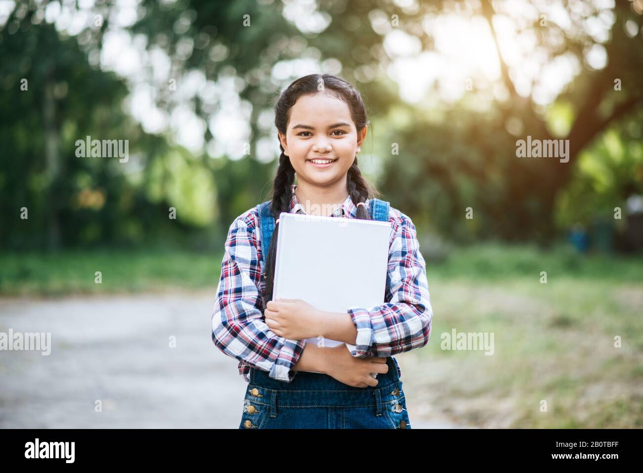 girl student hand hug book Stock Photo - Alamy