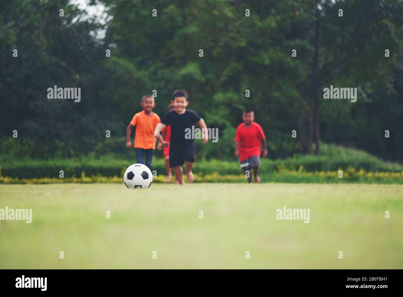 Kids playing soccer football Stock Photo - Alamy
