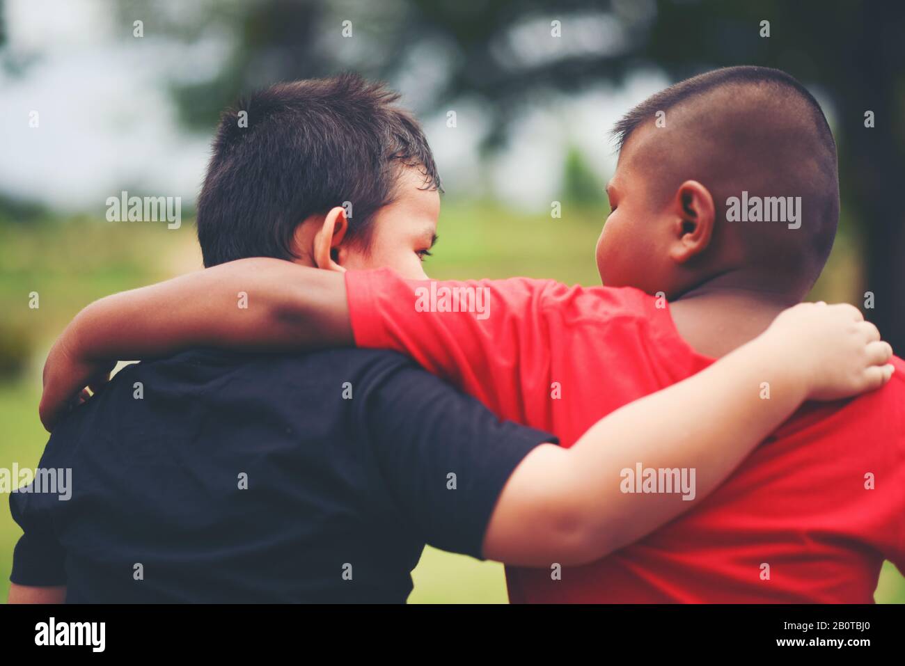 Group of kids friends arm around sitting together Stock Photo - Alamy