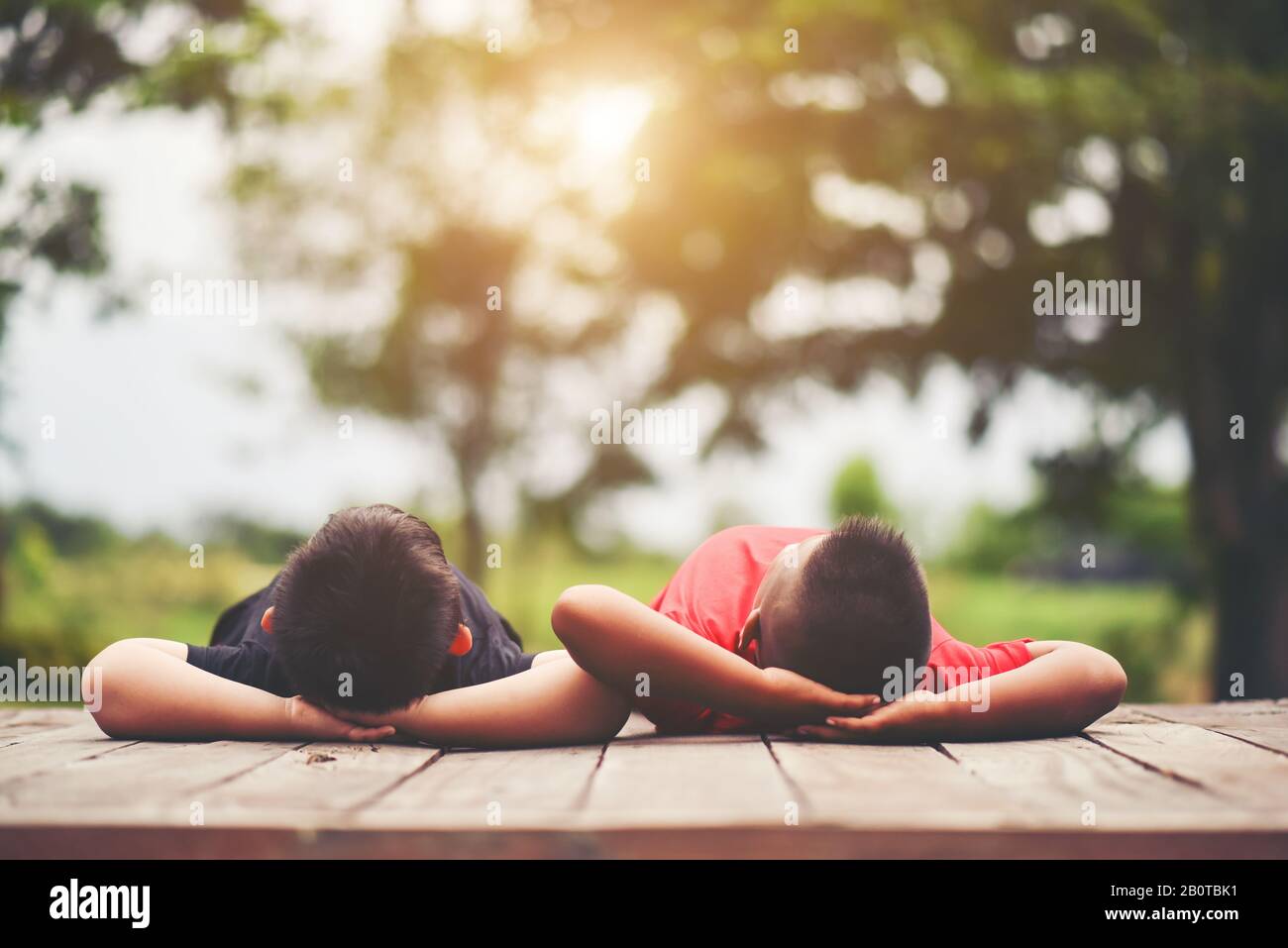 Group of kids friends arm around sitting together Stock Photo - Alamy