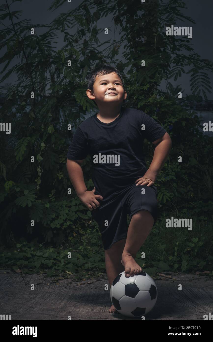 Little Boy playing soccer football Stock Photo - Alamy