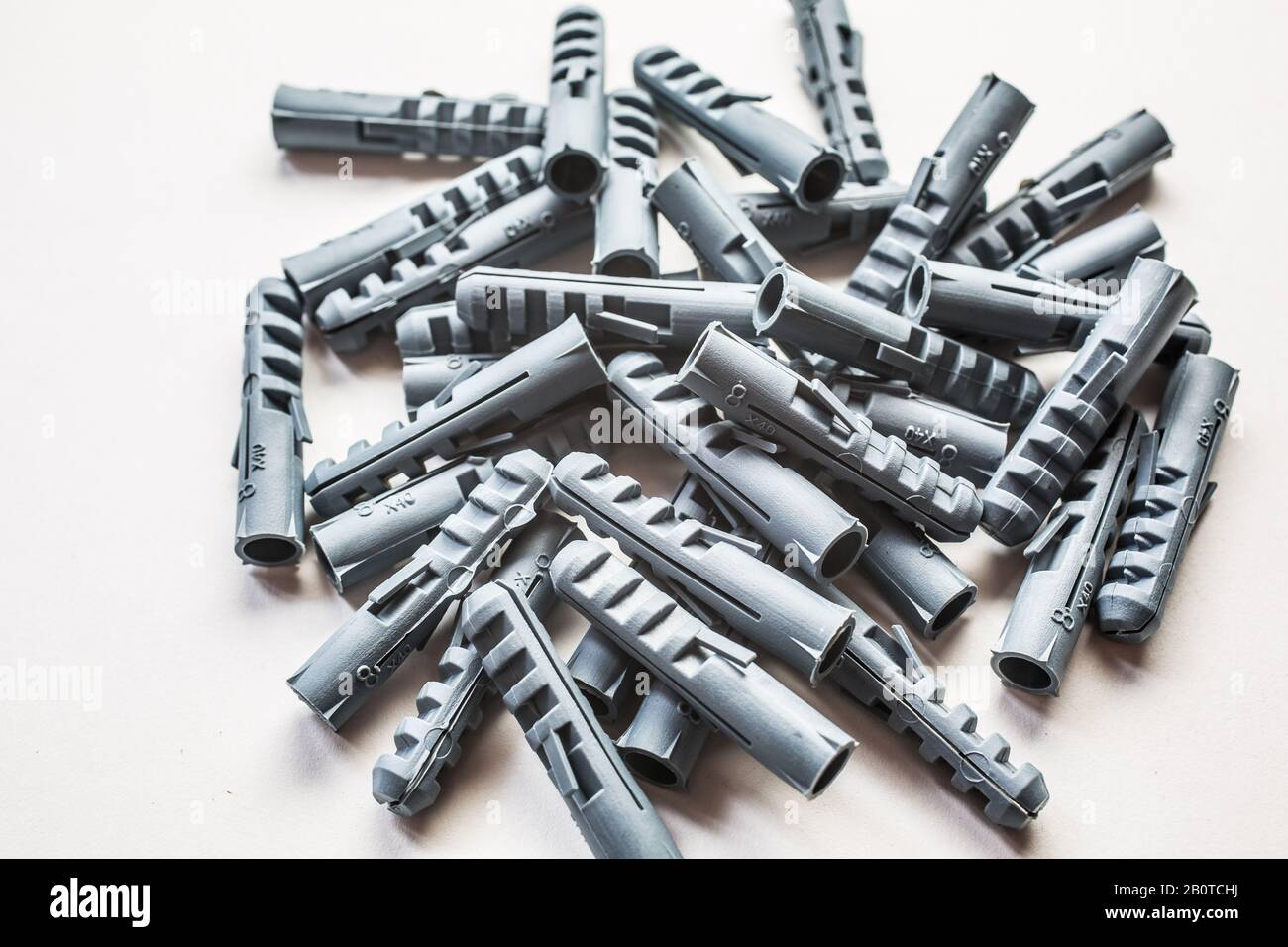 gray plastic dowels for wall mounting Stock Photo - Alamy