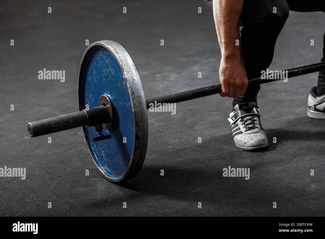 A part man's hand, doing sport exercise by lifting gymnastic barbell ...