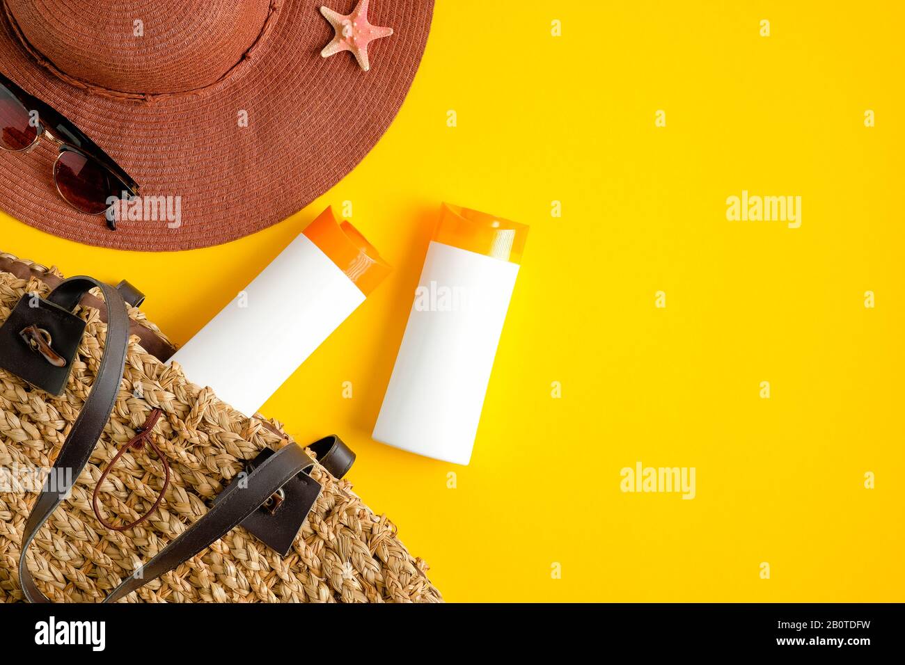 Flat lay summer sunscreen lotions bottles on yellow background with ...