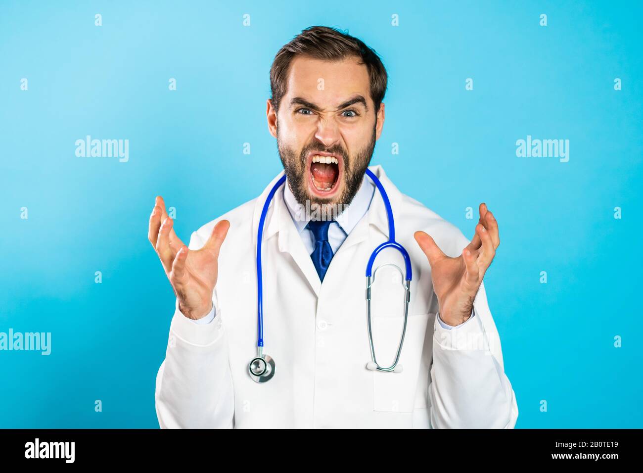 Angry doctor man in white coat screaming . Stressed and depressed man ...