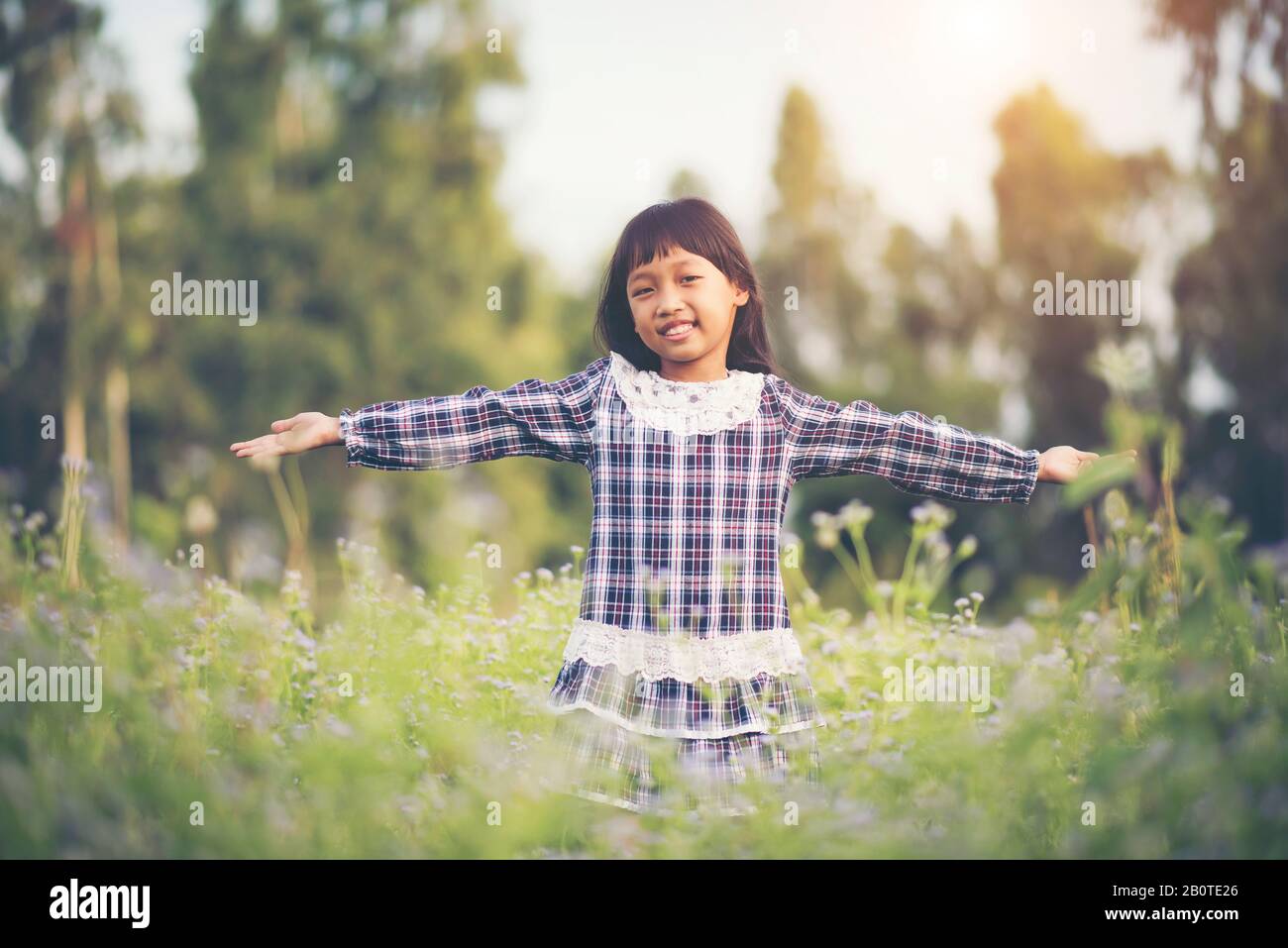 Little girl raising hand refresh in the air Stock Photo - Alamy