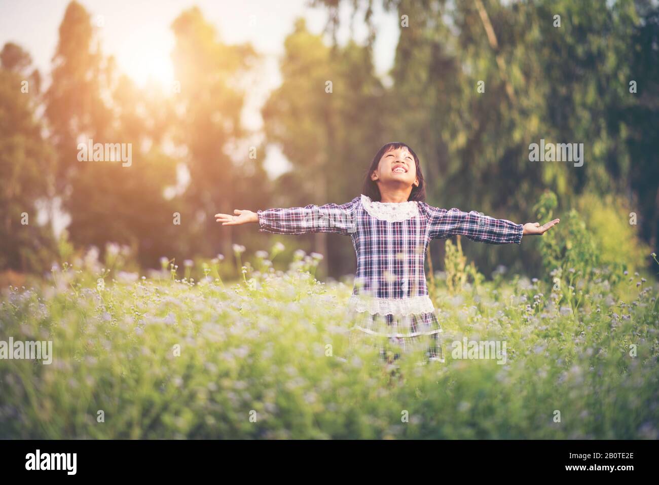 Little girl raising hand refresh in the air Stock Photo - Alamy