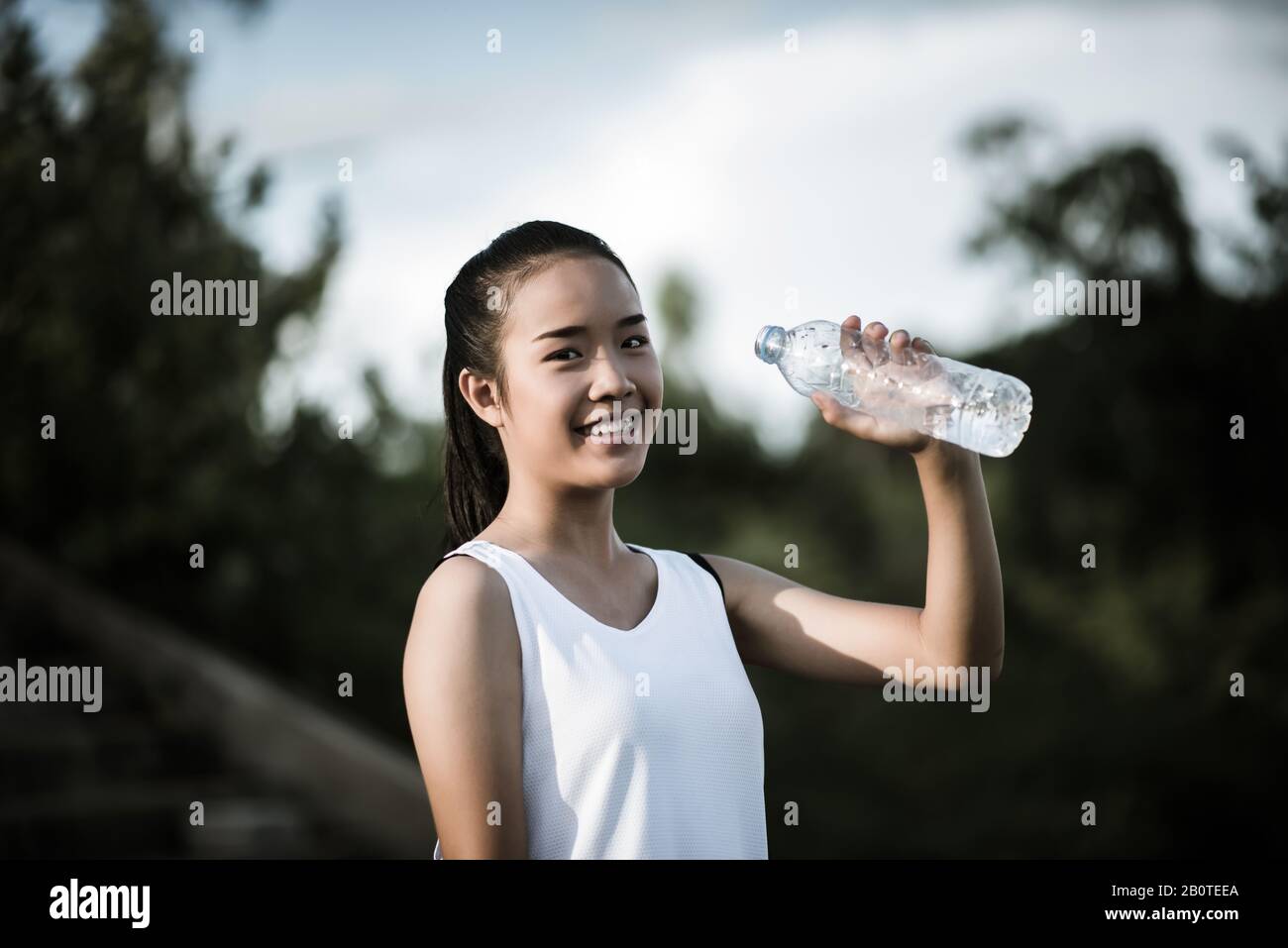 Young fitness woman hand holding water bottle after running exercise ...