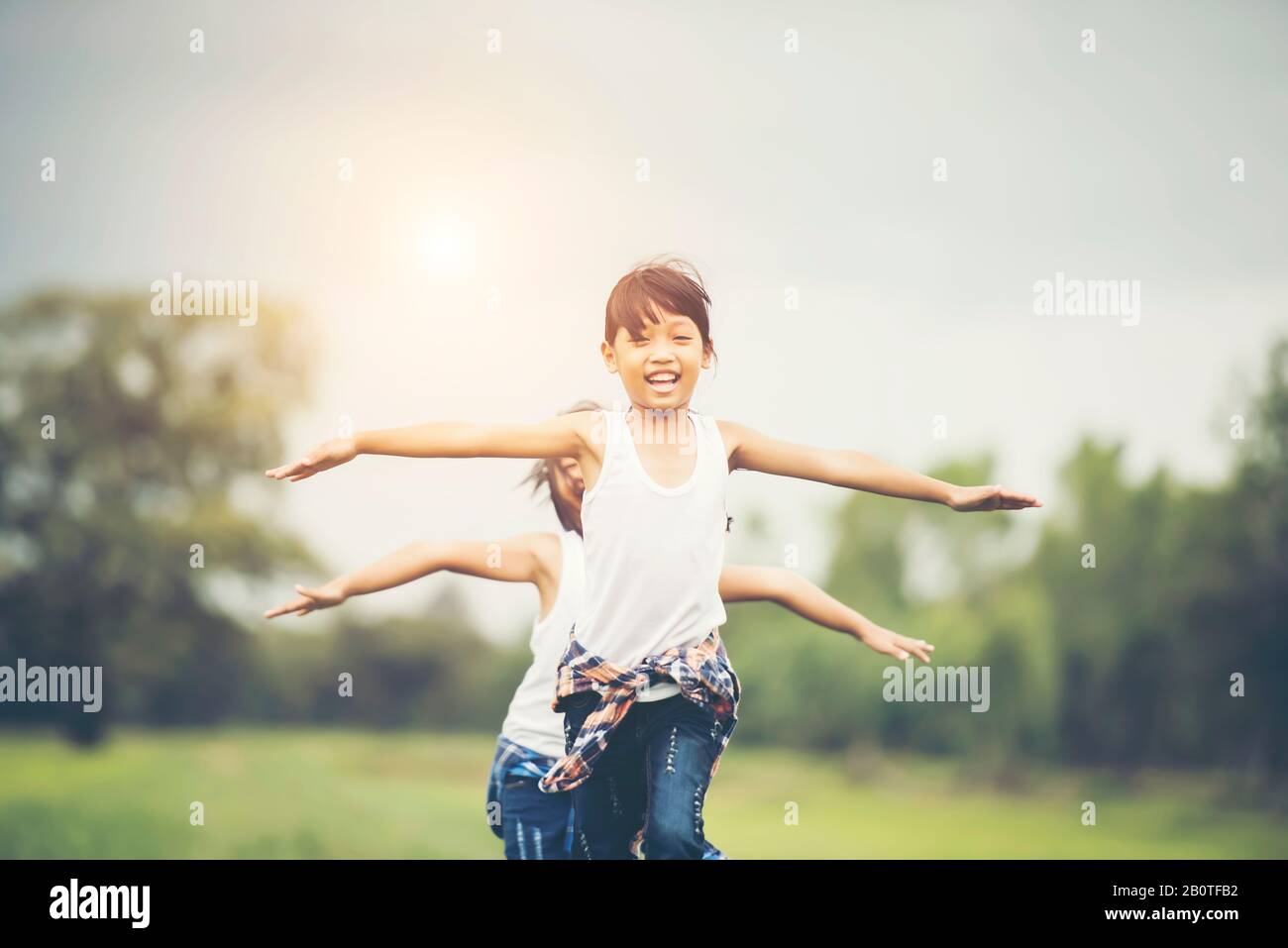 Two sister girls friends running hi-res stock photography and images ...