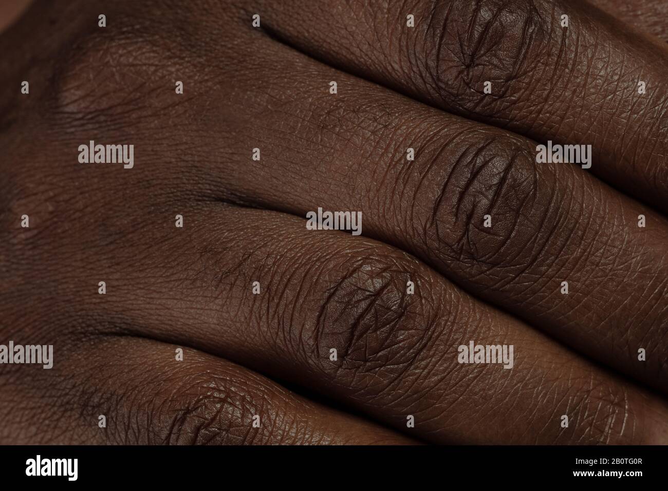 Fingers. Detailed texture of human skin. Close up shot of young african ...