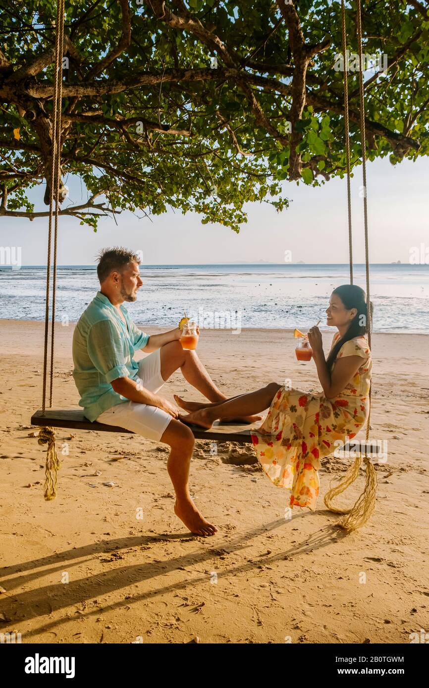 couple on the beach during sunset at the tropical Krabi area Thailand ...