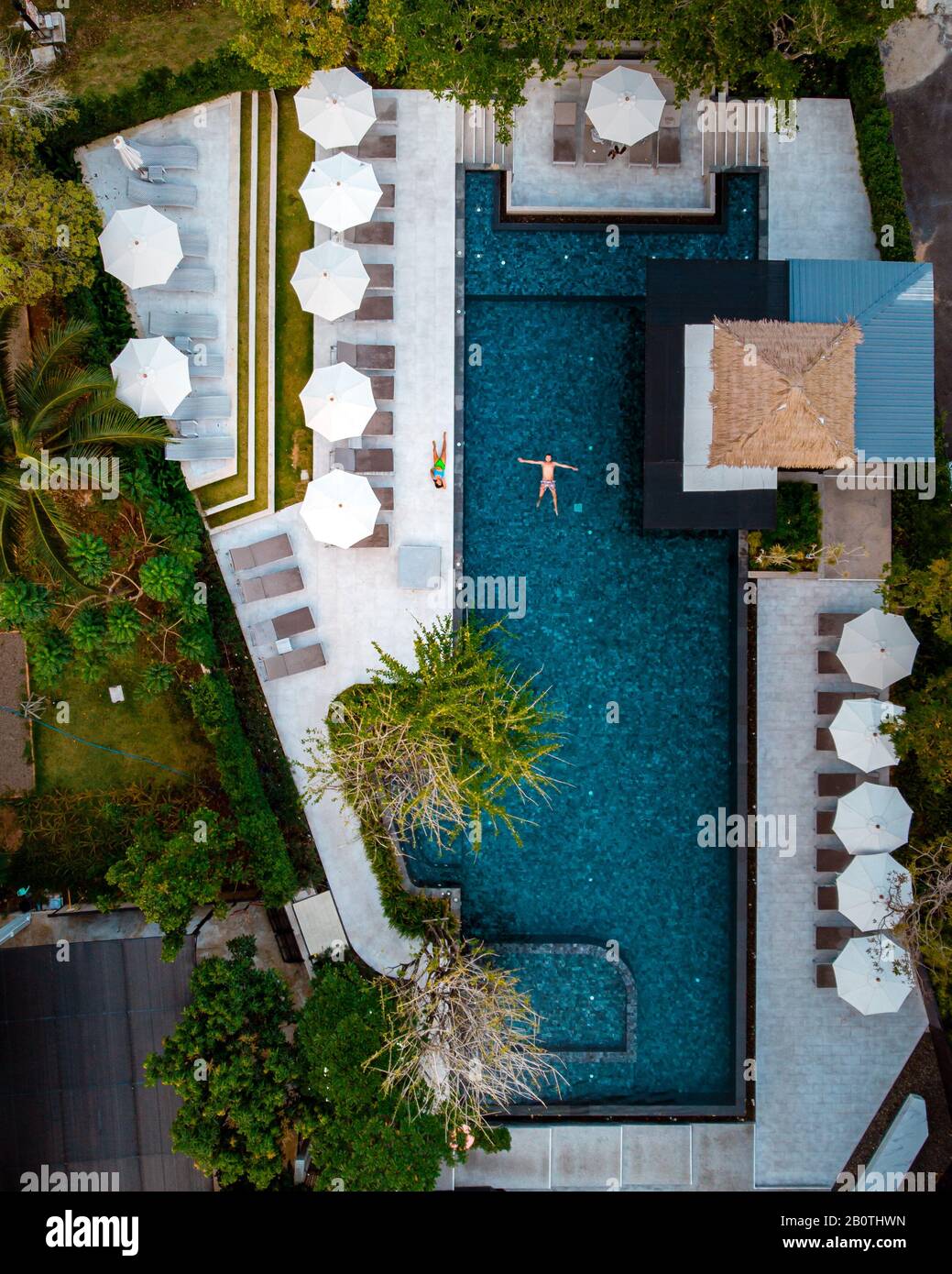 top view swimming pool, drone view pool, couple in swimming pool during ...