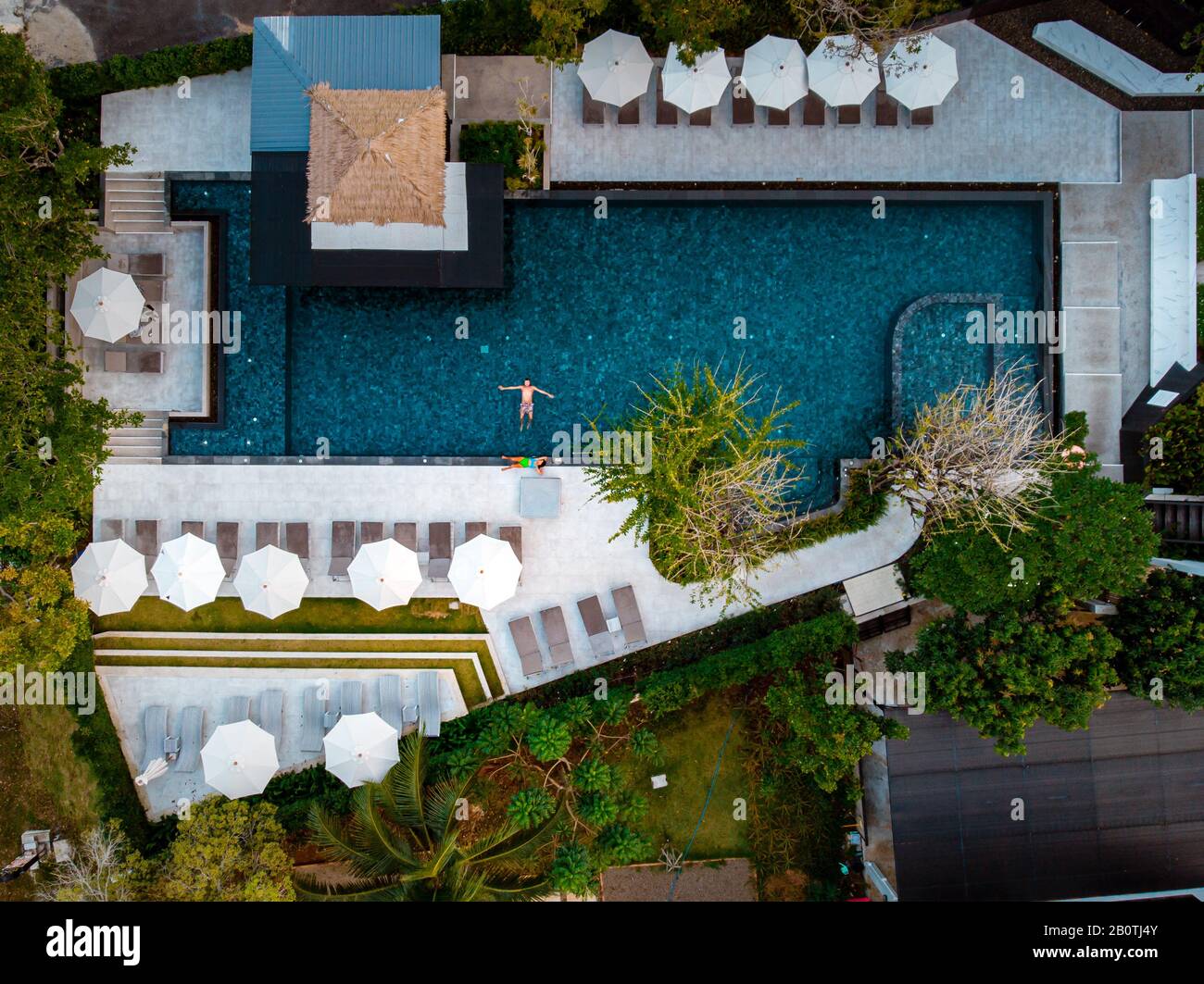 top view swimming pool, drone view pool, couple in swimming pool during ...