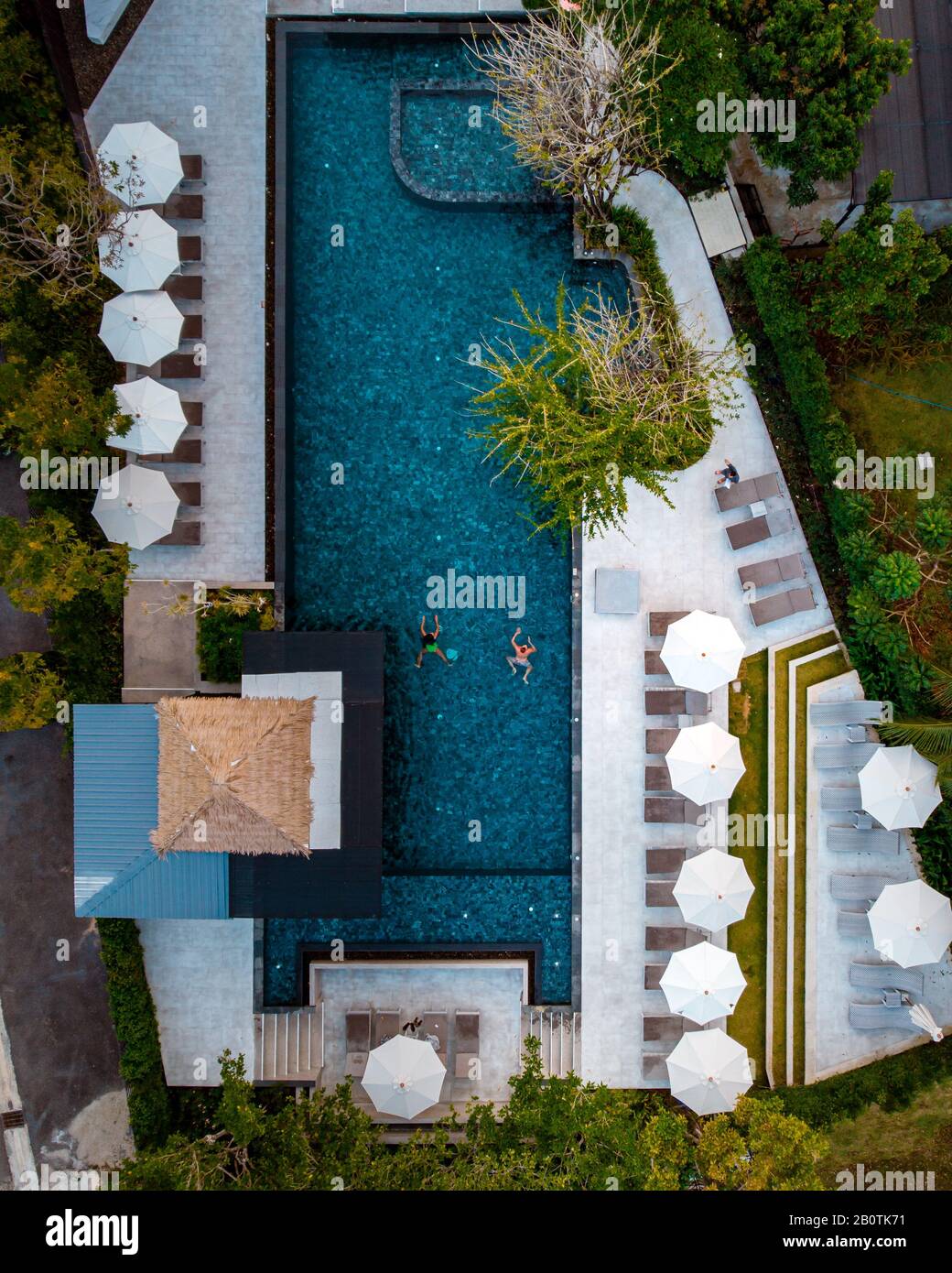 top view swimming pool, drone view pool, couple in swimming pool during ...