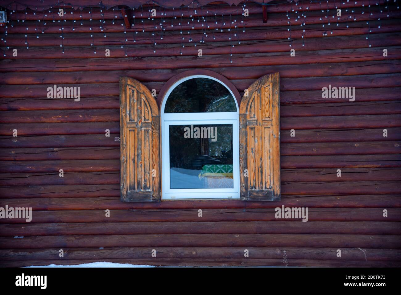 A window with wooden shutters against a cherry wood wall Stock Photo ...
