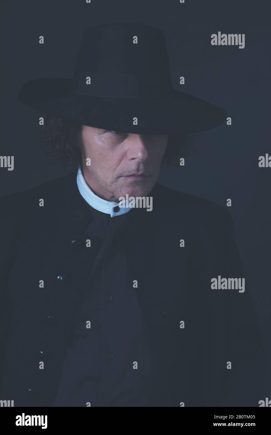 Mysterious victorian man in hat and black coat Stock Photo - Alamy