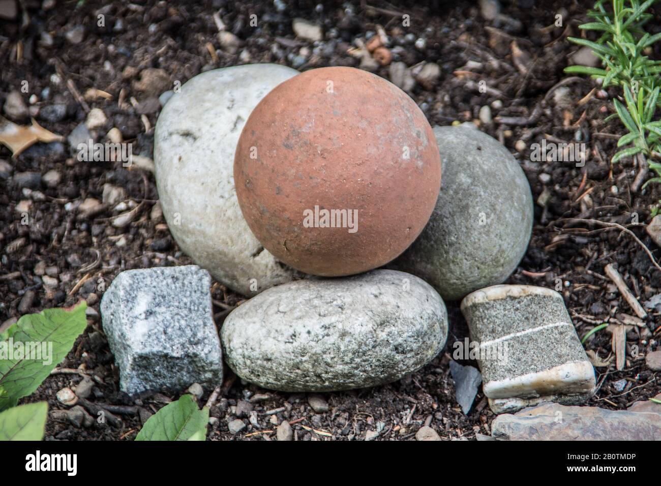 round stones in the rock garden bed Stock Photo - Alamy