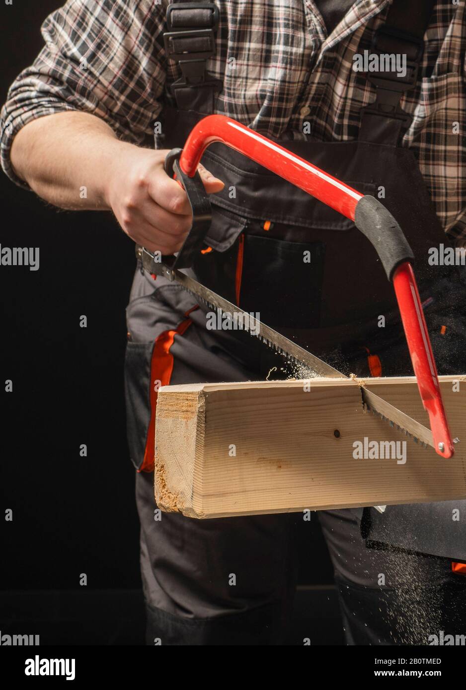 Close up of Carpenter sawing a board with a hand wood saw Stock Photo ...