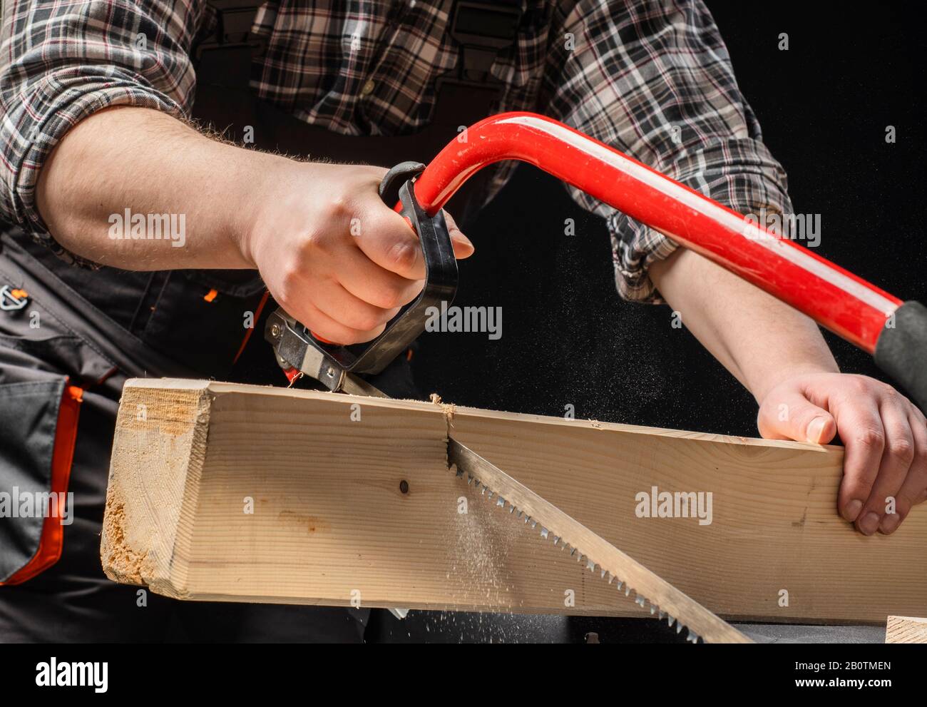 Close up of Carpenter sawing a board with a hand wood saw Stock Photo ...