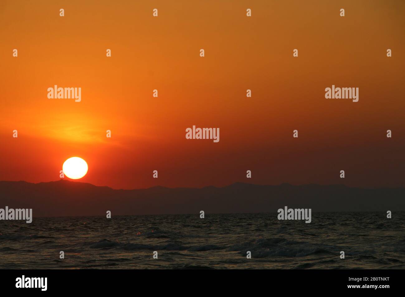 Dramatic sun setting on the beach. Wide landscape Stock Photo - Alamy