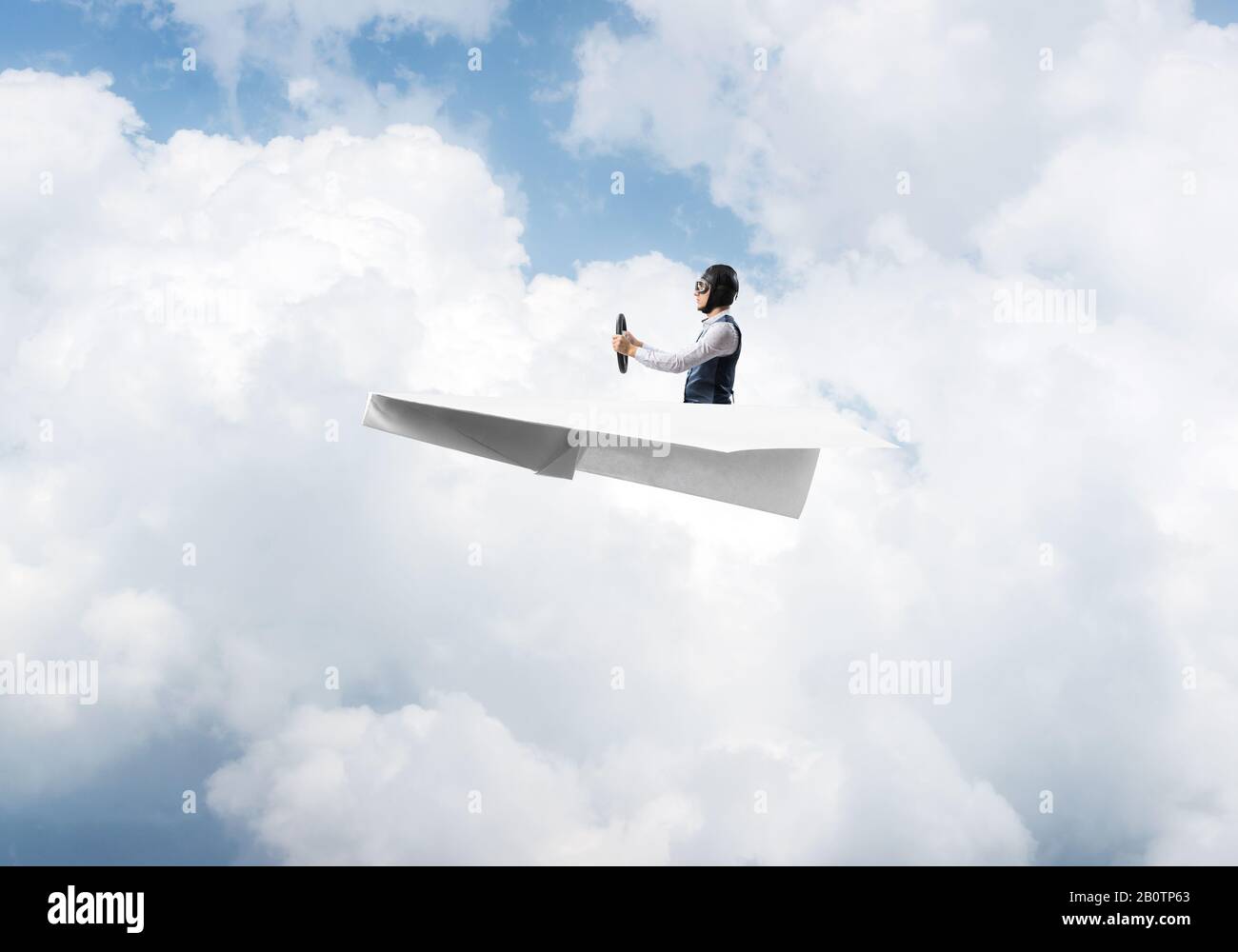 Pilot in leather helmet driving paper plane Stock Photo - Alamy
