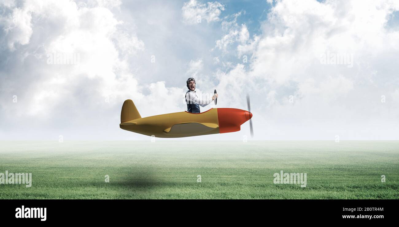 Man in airplane flying low above green meadow Stock Photo - Alamy